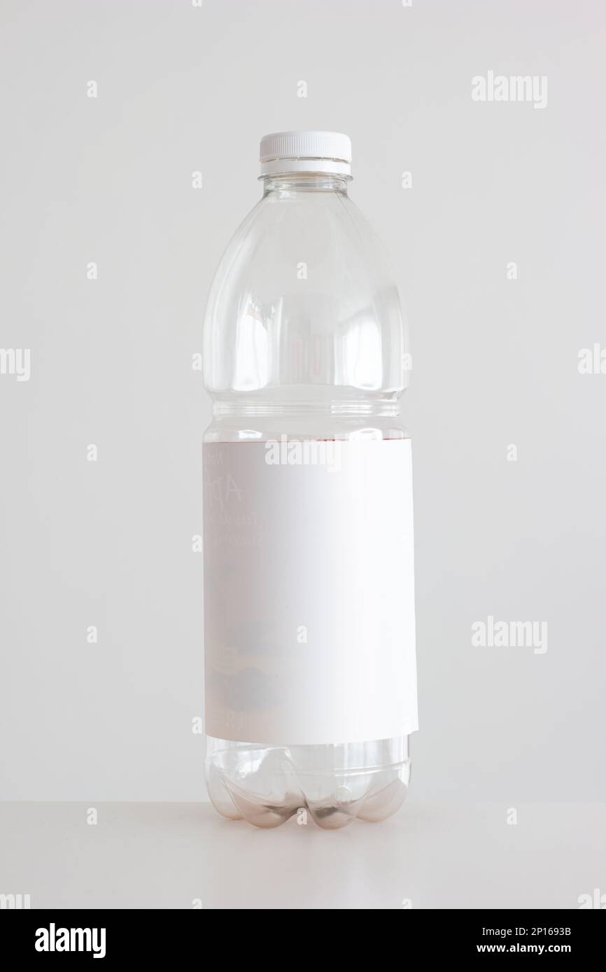 Clear empty plastic bottle with red lid and white empty label isolated ...