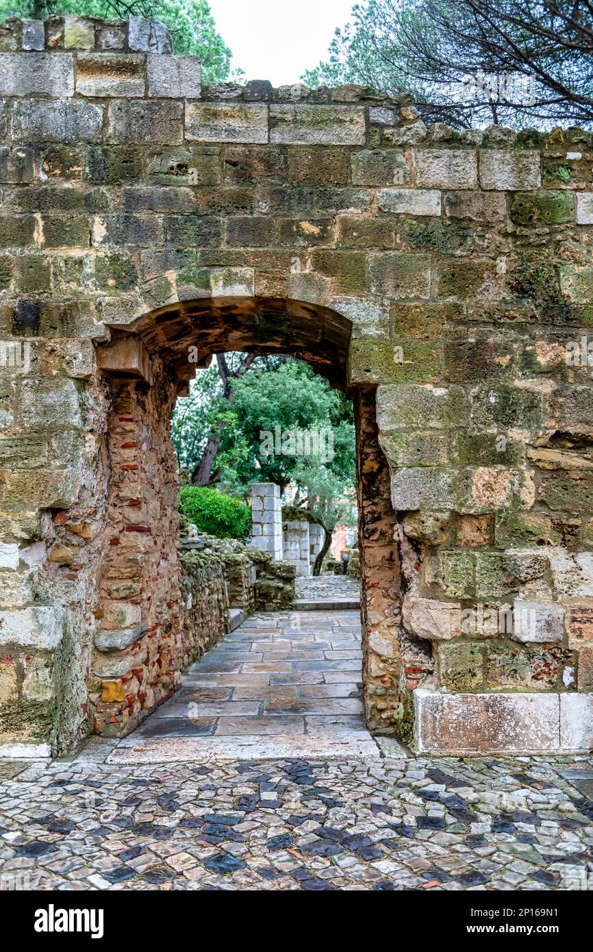 An arched door in a stone wall inside of the military fort which is a ...