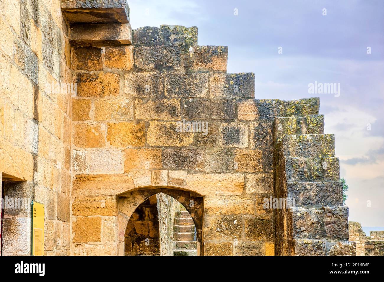 Arched door in a stone wall inside of the former military building ...