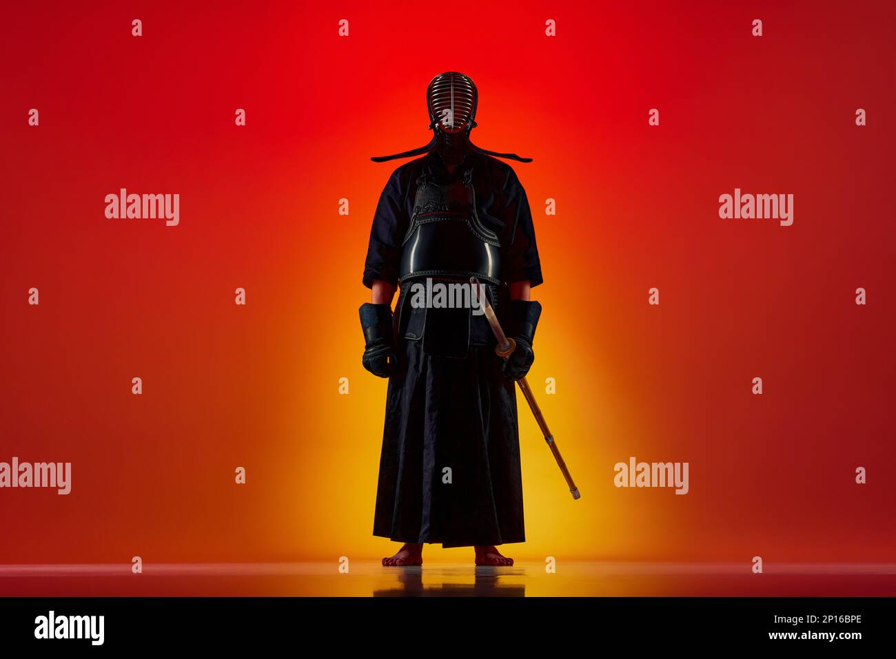 Portrait of man, professional kendo athlete in uniform posing with ...