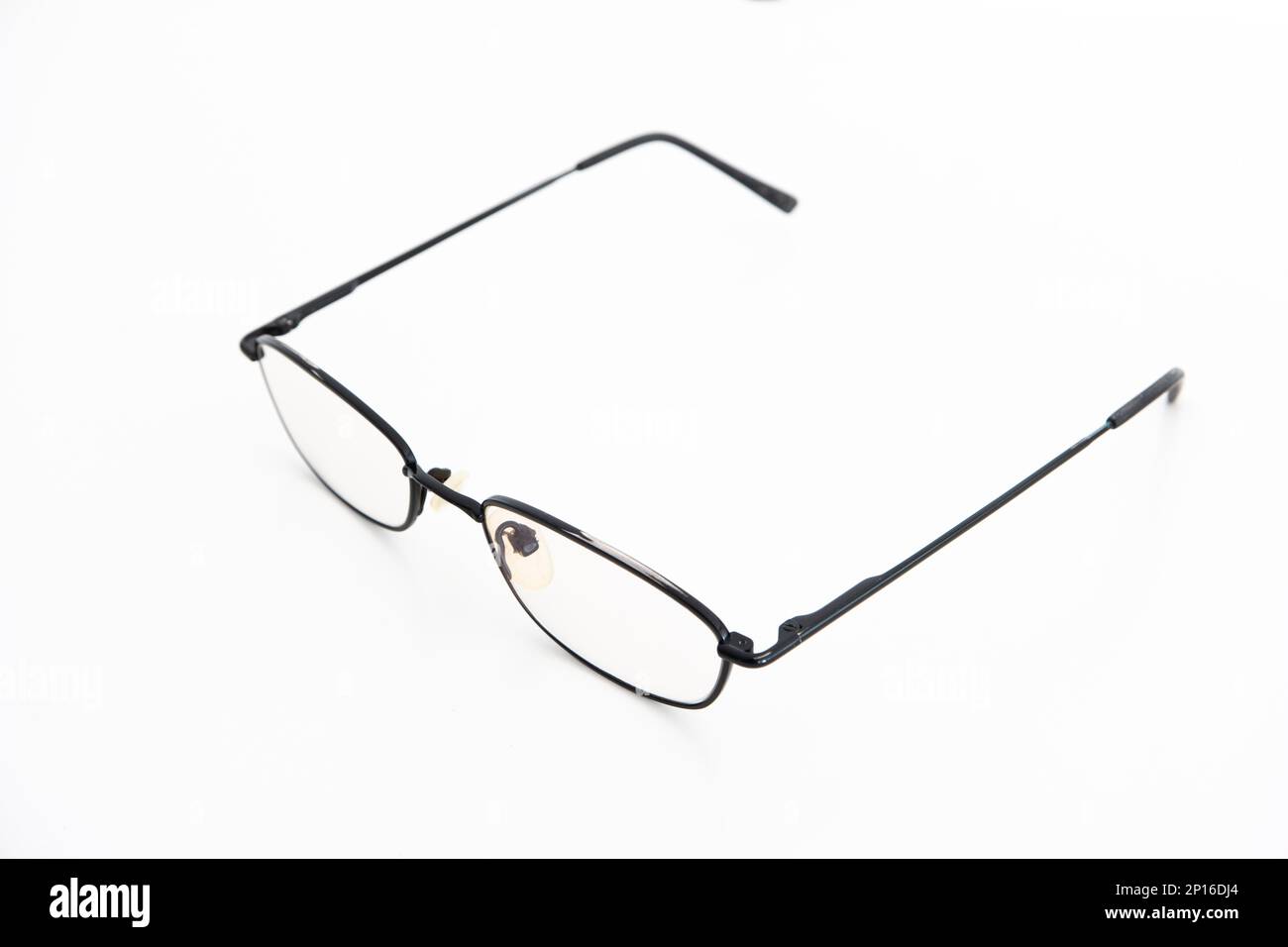 Simple used black metal wire glasses frame and lens close up studio ...