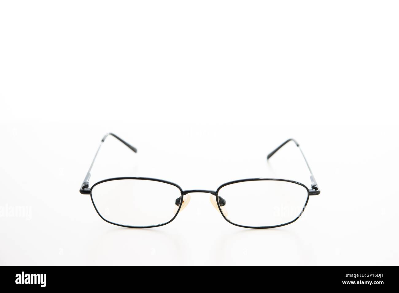 Simple used black metal wire glasses frame and lens close up studio ...