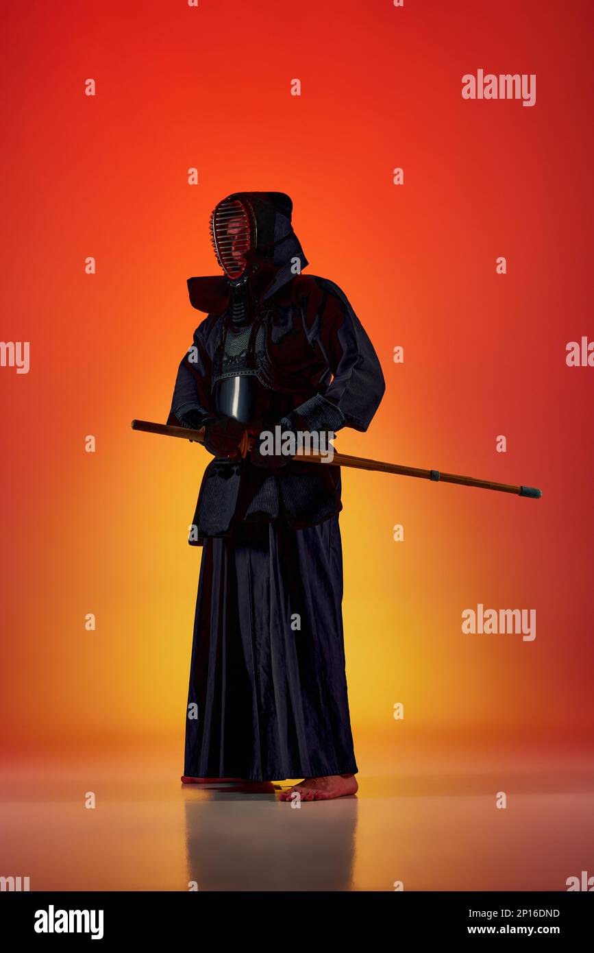 Full-length portrait of man, professional kendo athlete in uniform ...