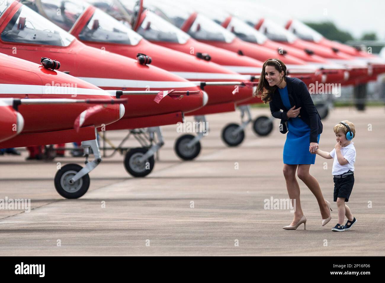 Prince George, right, wears ear defenders against the roar of aircraft ...
