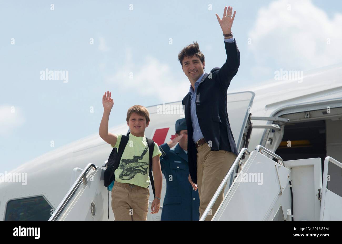 Canadian Prime Minister Justin Trudeau and his son, Xavier, wave while ...