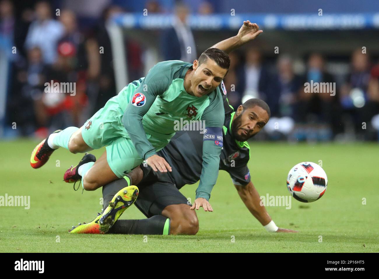 Portugal's Cristiano Ronaldo, left, falls after a tackle by Wales ...