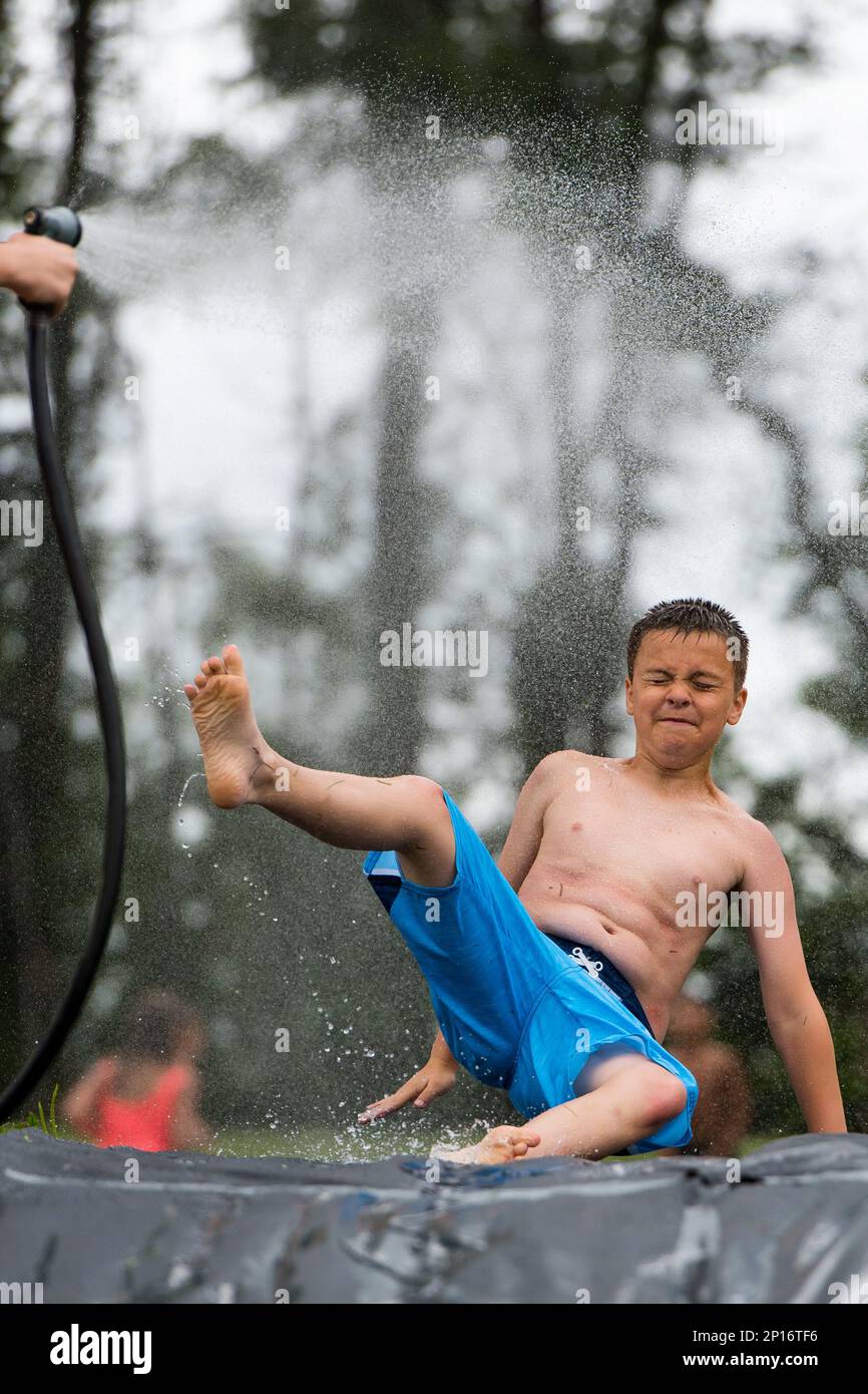 Cameron Rollett wipes out on the Slip 'N Slide as his sister Libby ...