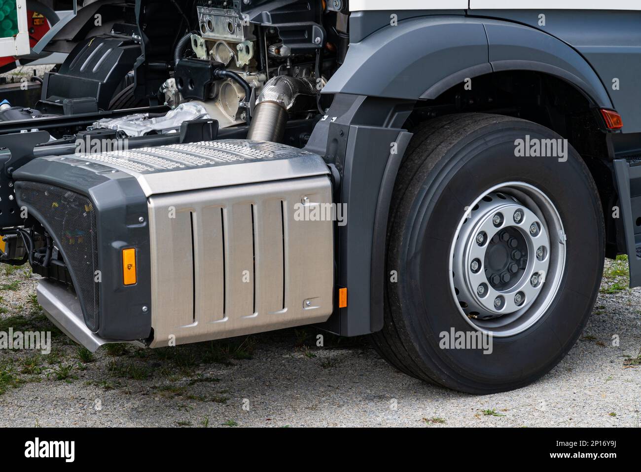 View of the motor part of a semi truck. Front wheel and part of the ...