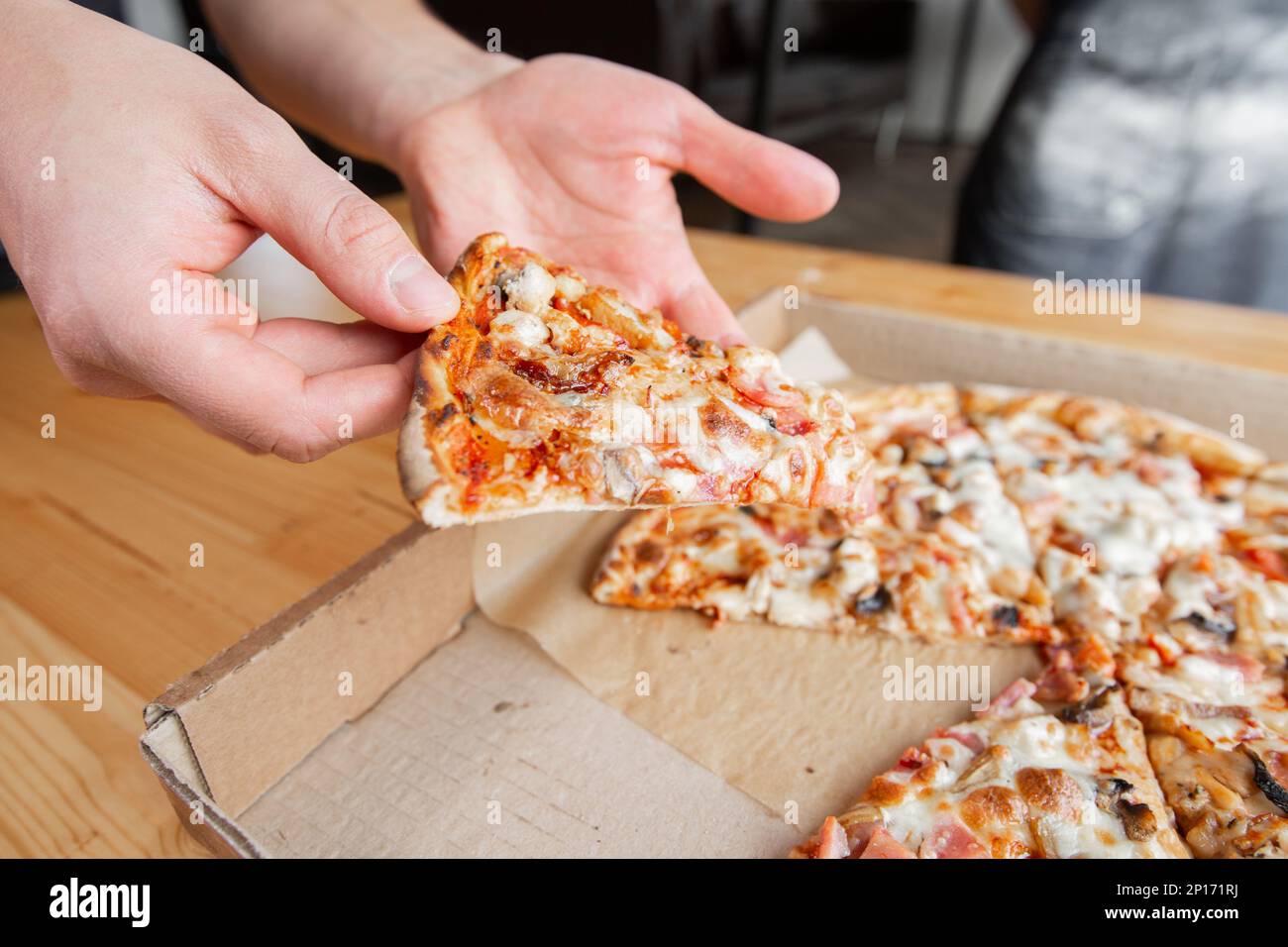 one people taking slices of pizza out of the box. fast delivery of food ...