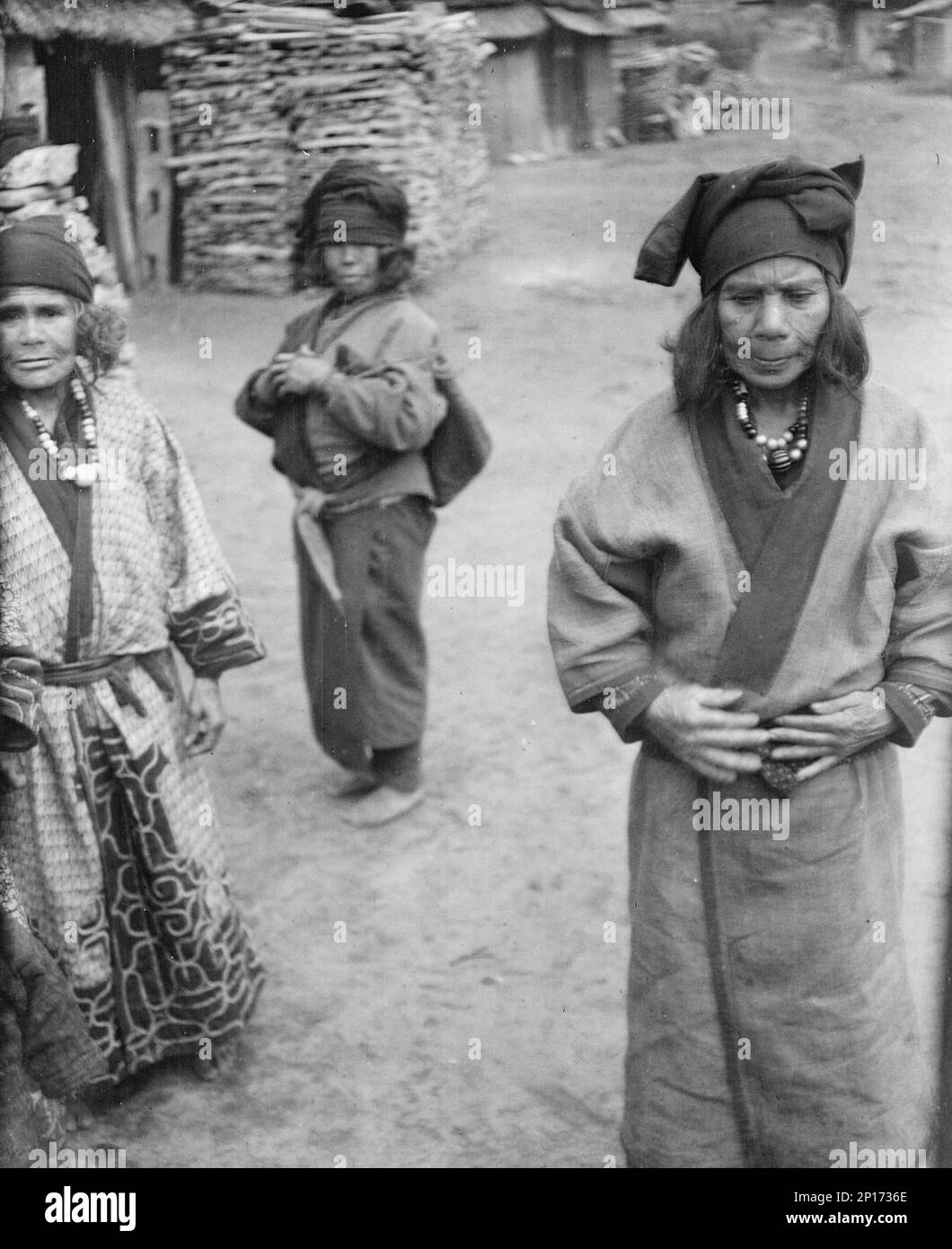 Three Ainu women outside in the village lane, 1908 Stock Photo - Alamy
