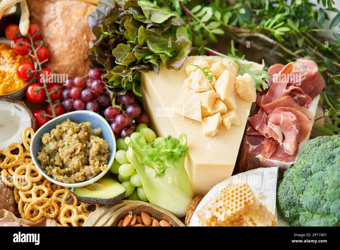 Parmesan cheese with honey close-up. Table full of mediterranean ...