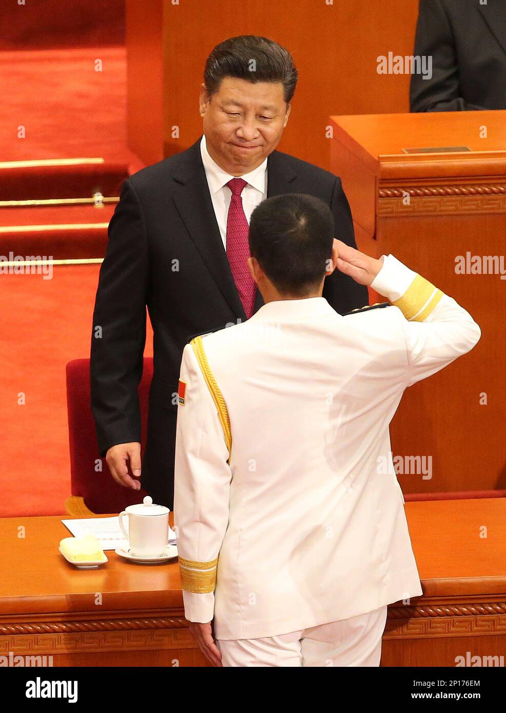 A Chinese military officer salutes President Xi Jinping before ...