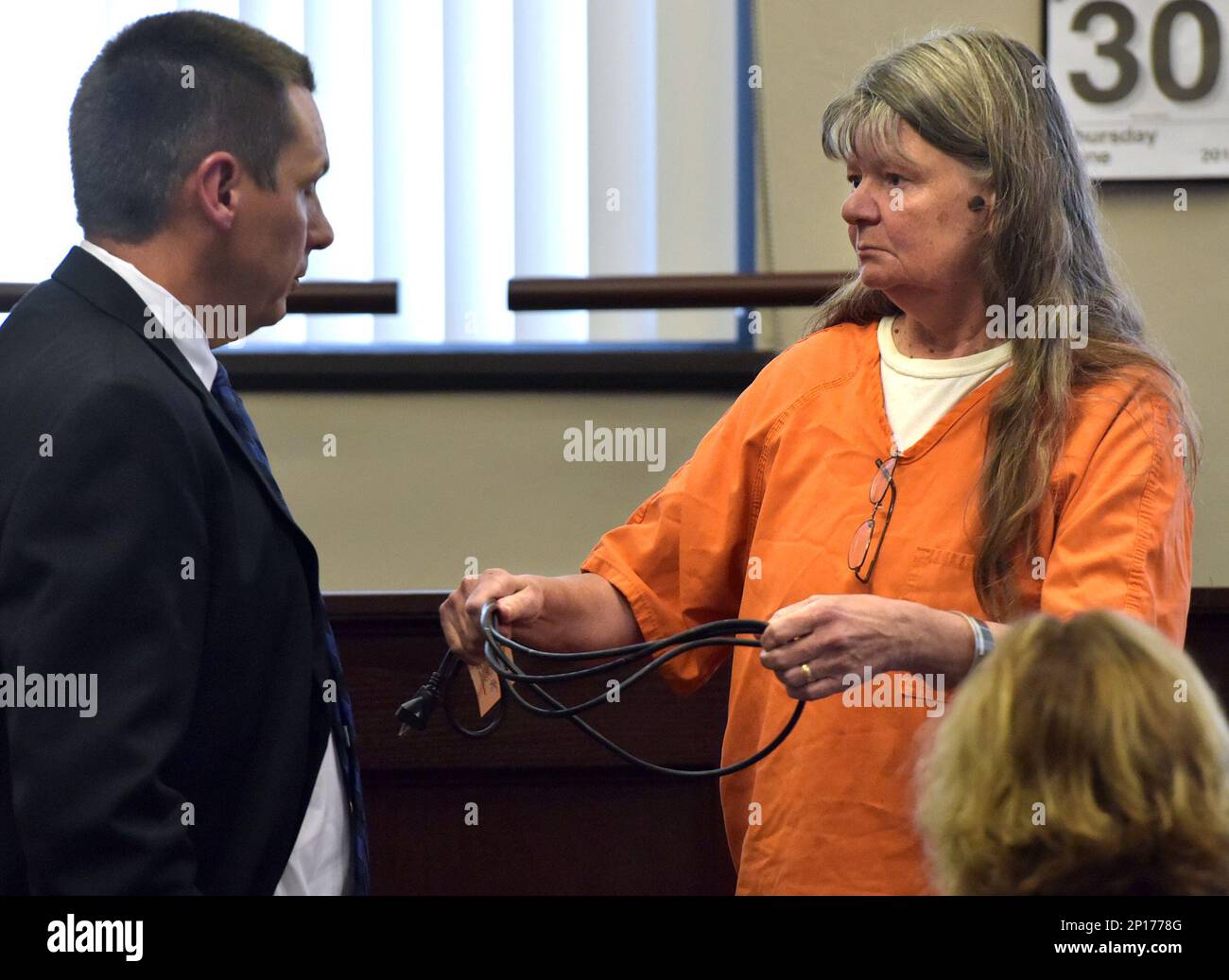 From left, Oneida County District Attorney Scott McNamara watches as ...