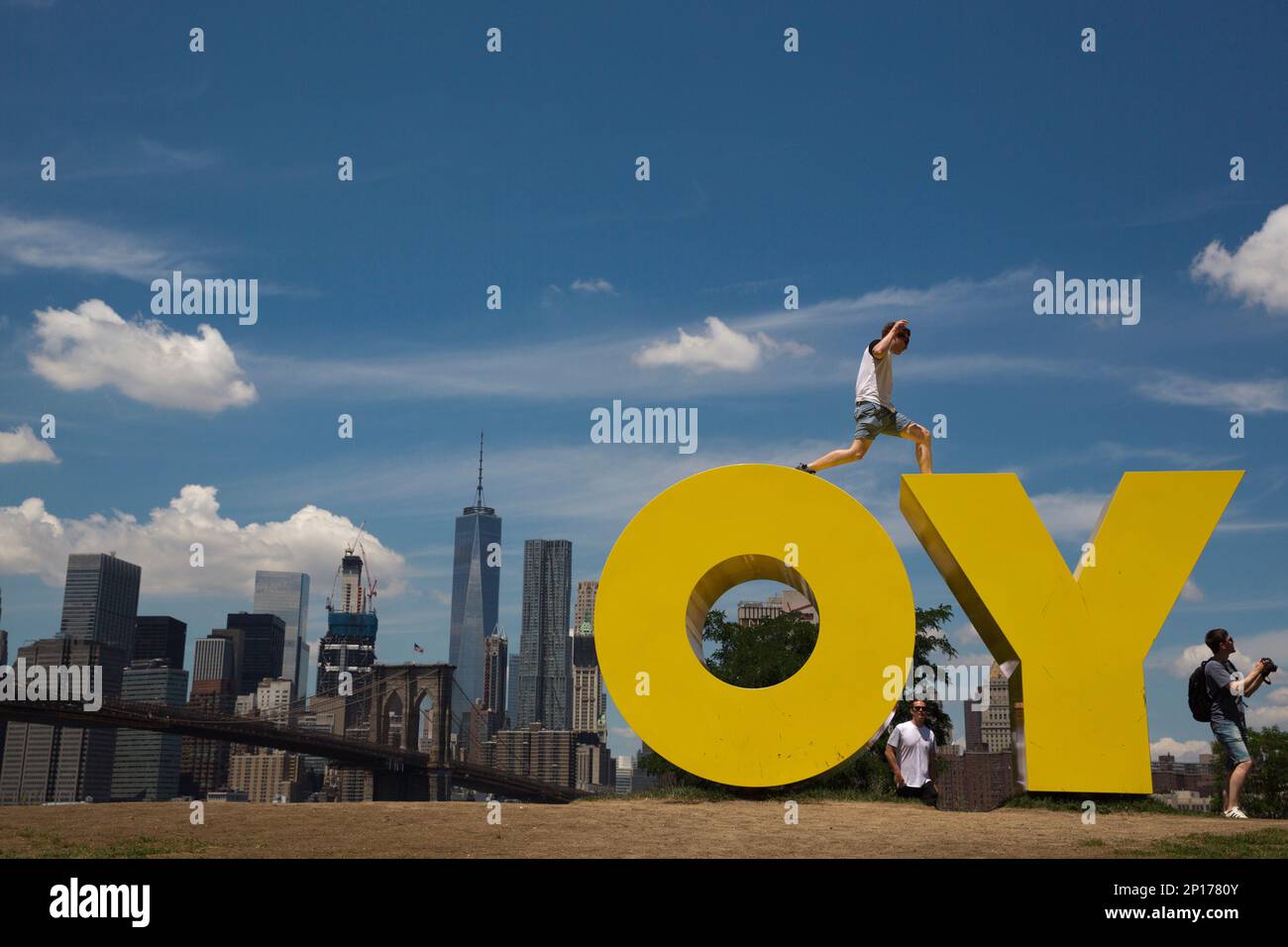 A visitor to the Brooklyn Bridge park jumps between the letters in ...