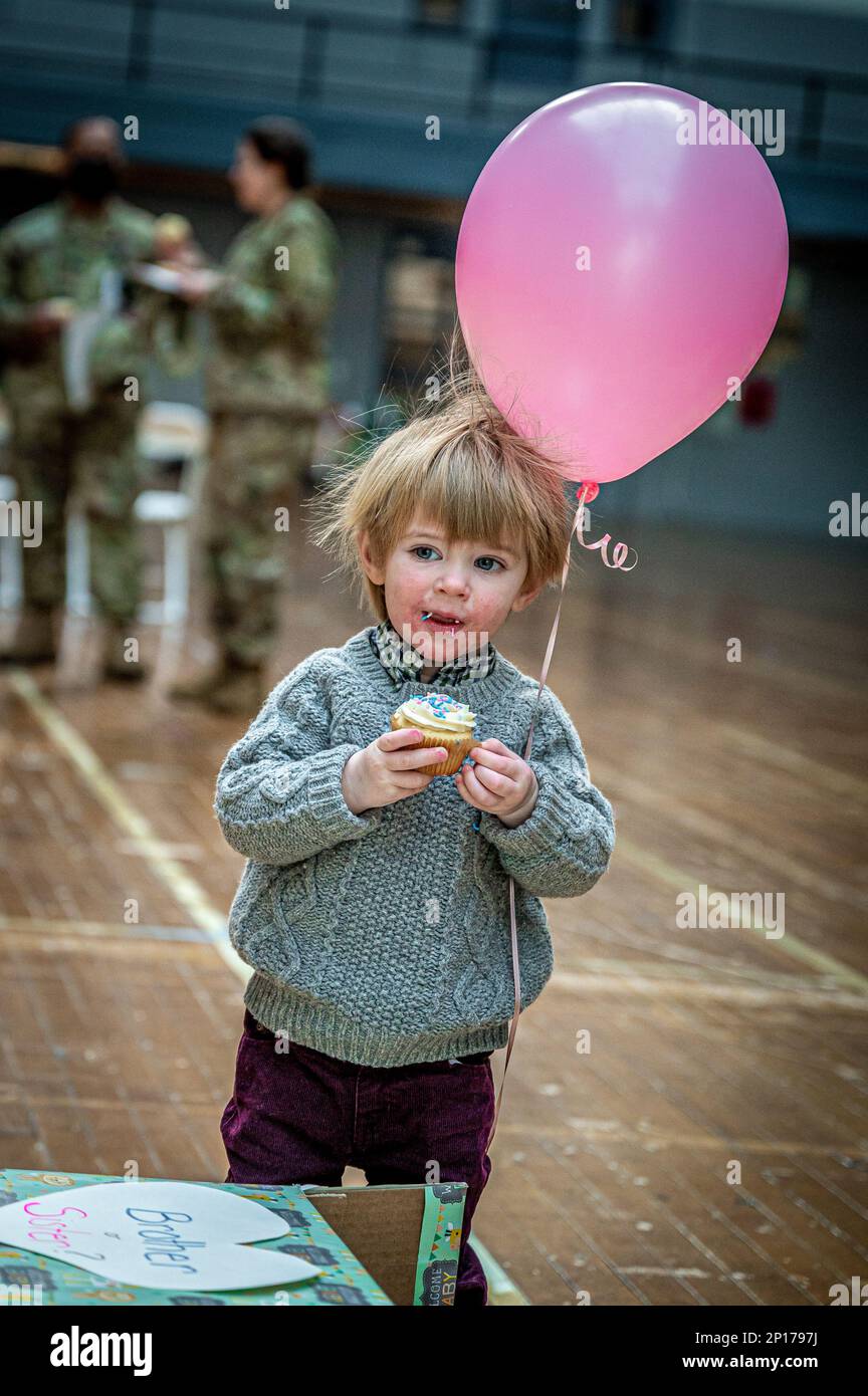 Barrett Henderson, son of U.S. Army Maj. Emily Hein, holds a pink ...