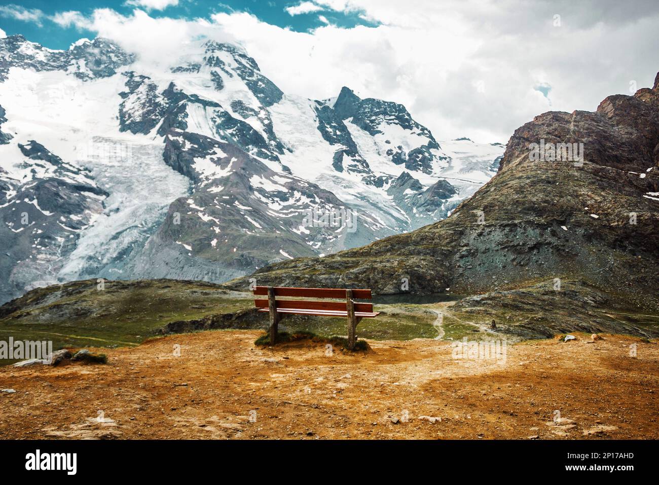 Bench among snow mountains. Zermatt, Swiss Alps. Place for loneliness ...