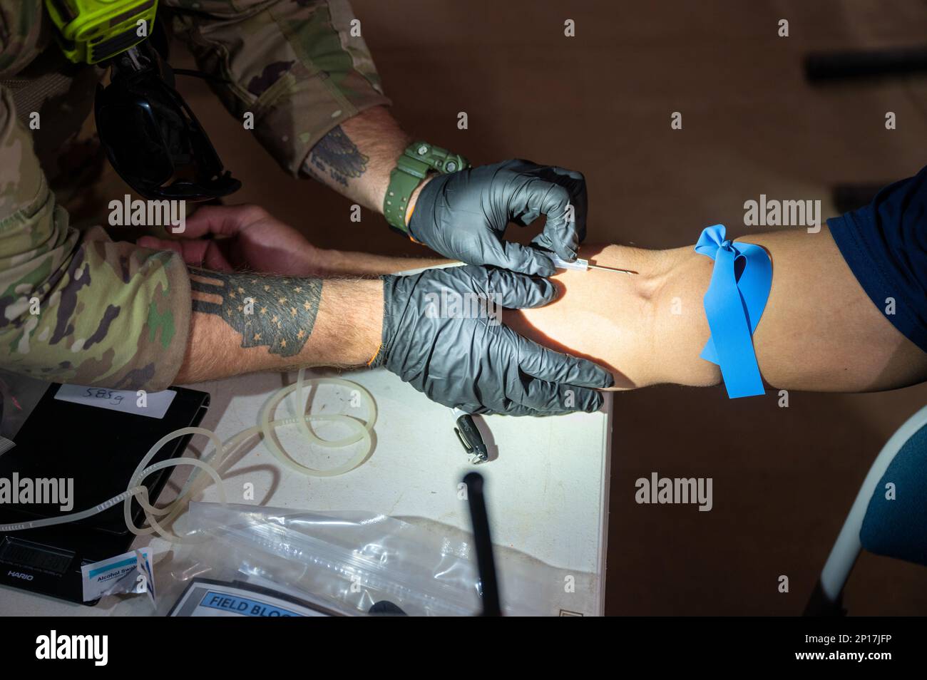 U.S. Air Force Staff Sgt. Antonio Cap prepares to insert a needle into ...