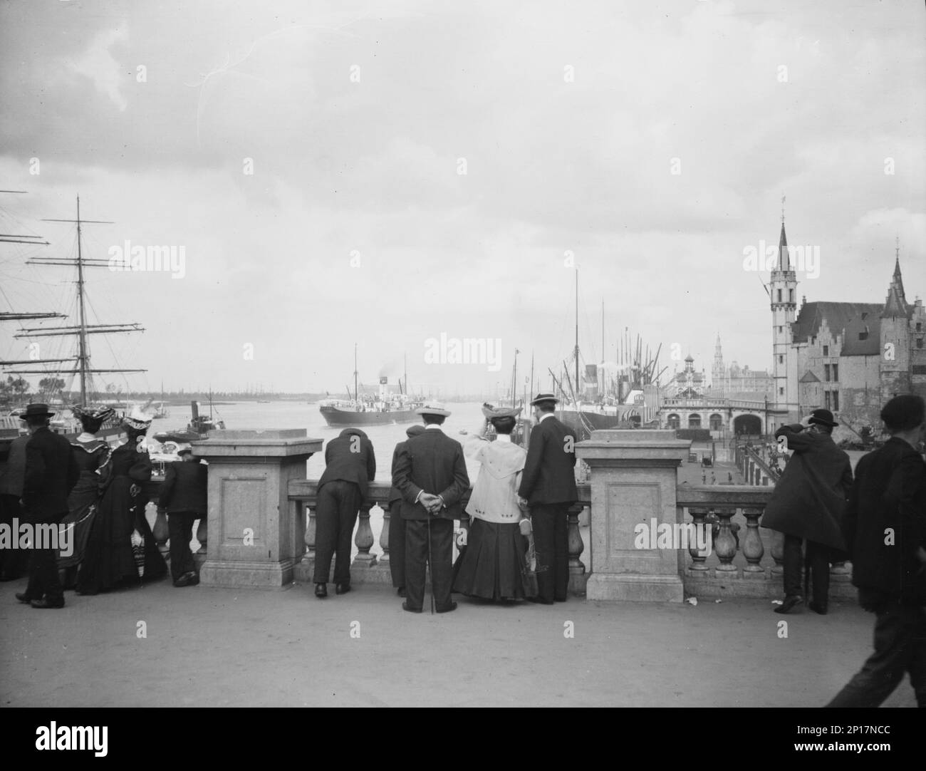 Travel views of Europe, 1900s. Group of people watching ships in a port ...