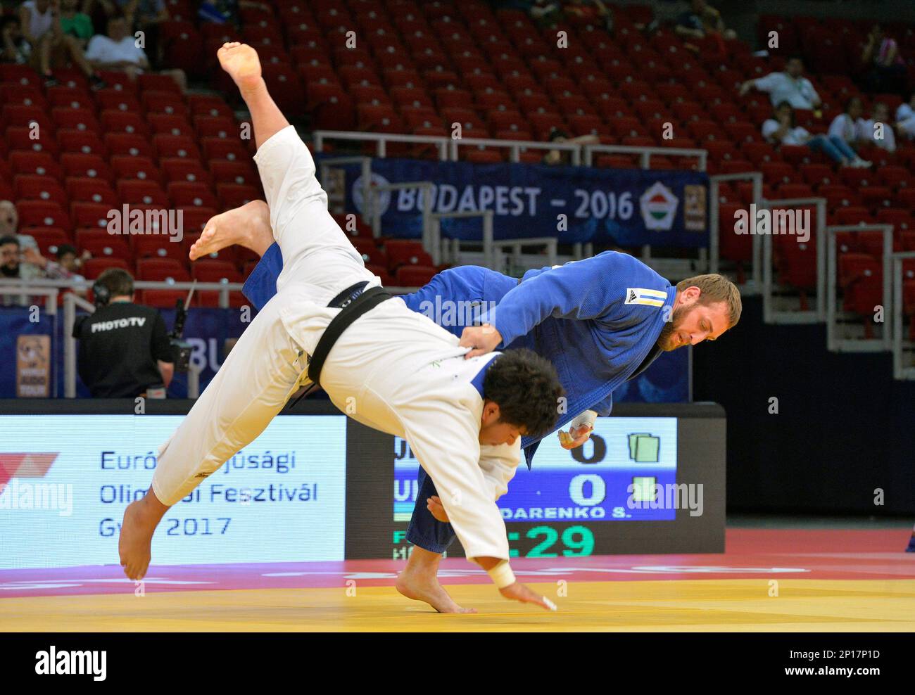 Stanislav Bondarenko, in blue, of Ukraine defeats Katsuma Ueda of Japan ...
