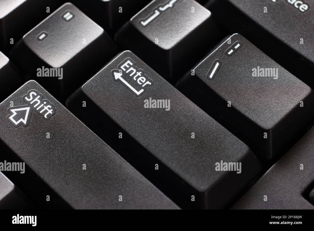 Black plastic standard English computer keyboard close up macro shot ...
