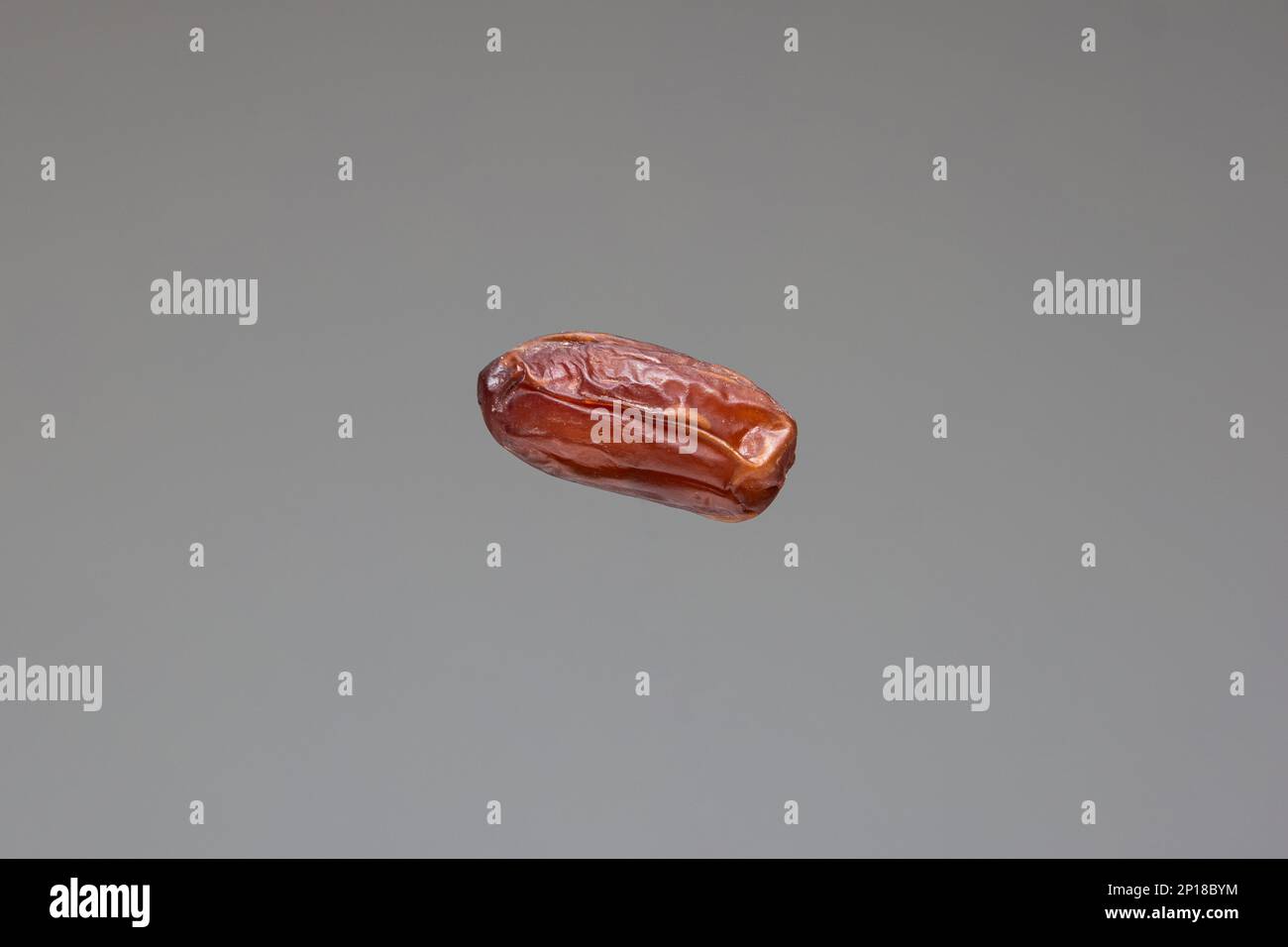Dried ripe date fruit close up studio shot isolated on gray background ...