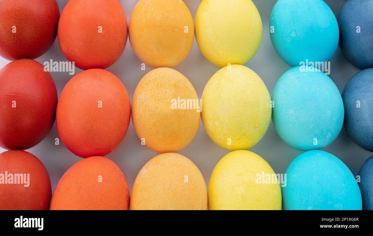 Easter eggs background. The eggs are painted in the same colors of the ...