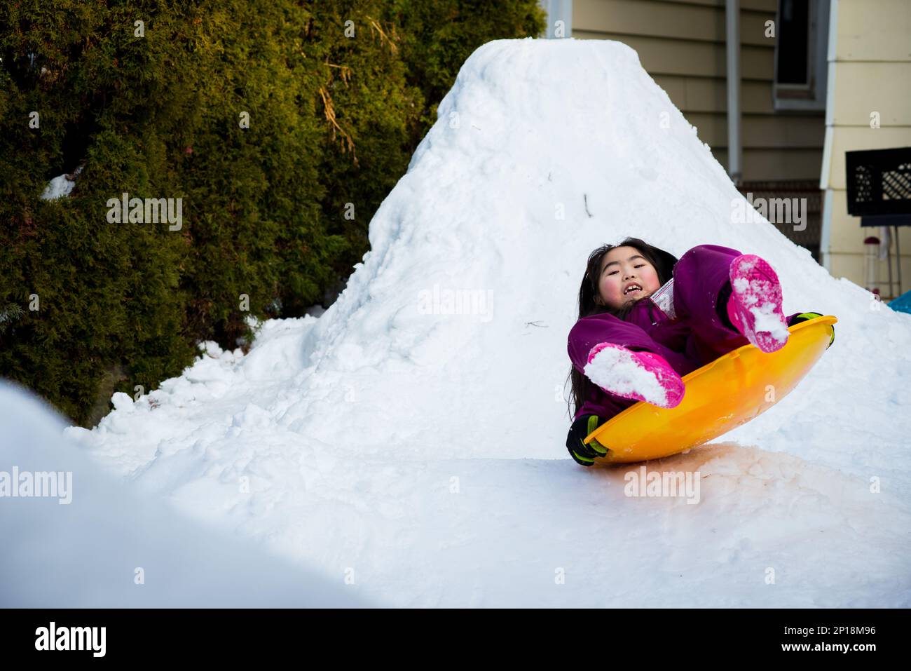 Young asian girl sledding after snow Stock Photo - Alamy