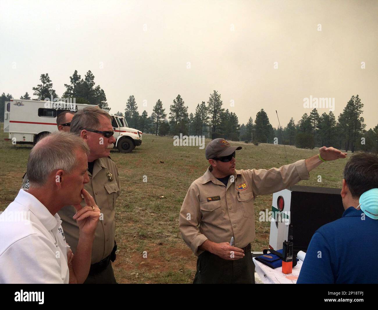 Navajo County Sheriff KC Clark, second from left, listens during a ...
