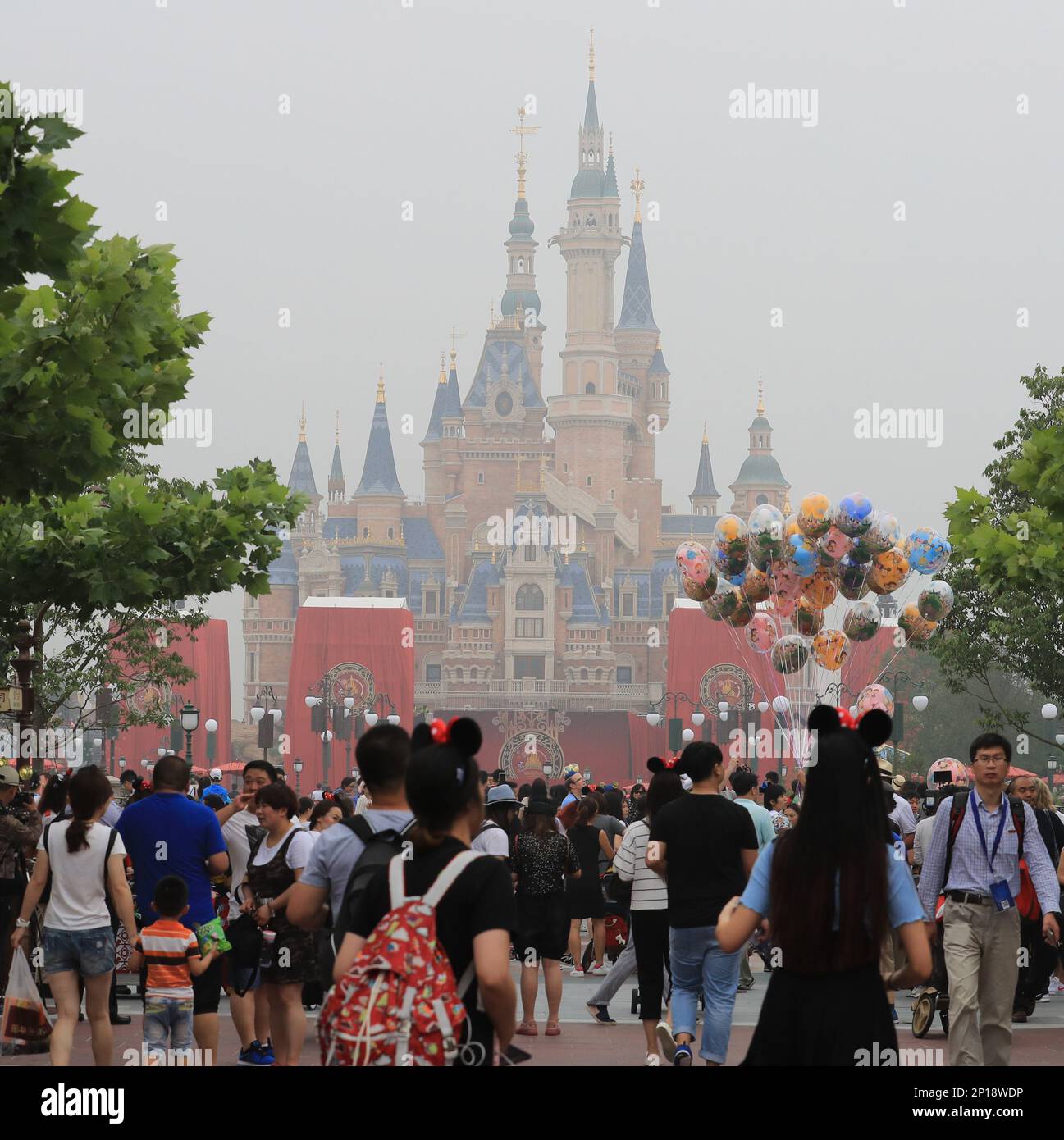 People visit Shanghai Disneyland on the opening day on June 16, 2016 ...