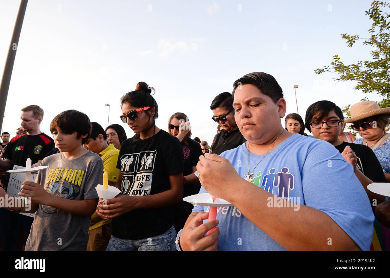 Monica Yazzie shields her candle from the breeze during a vigil Monday ...