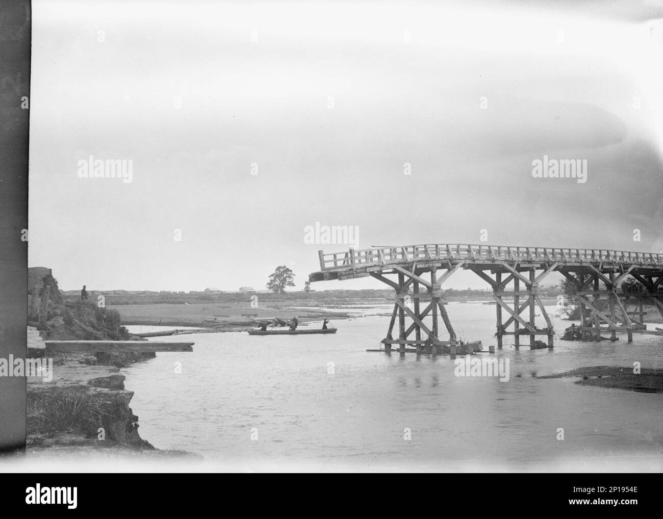 Bridge partially extended over a body of water, Japan, 1908 Stock Photo ...