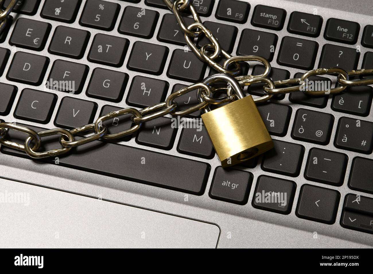 Computer security concept with an iron chain and padlock on the laptop ...