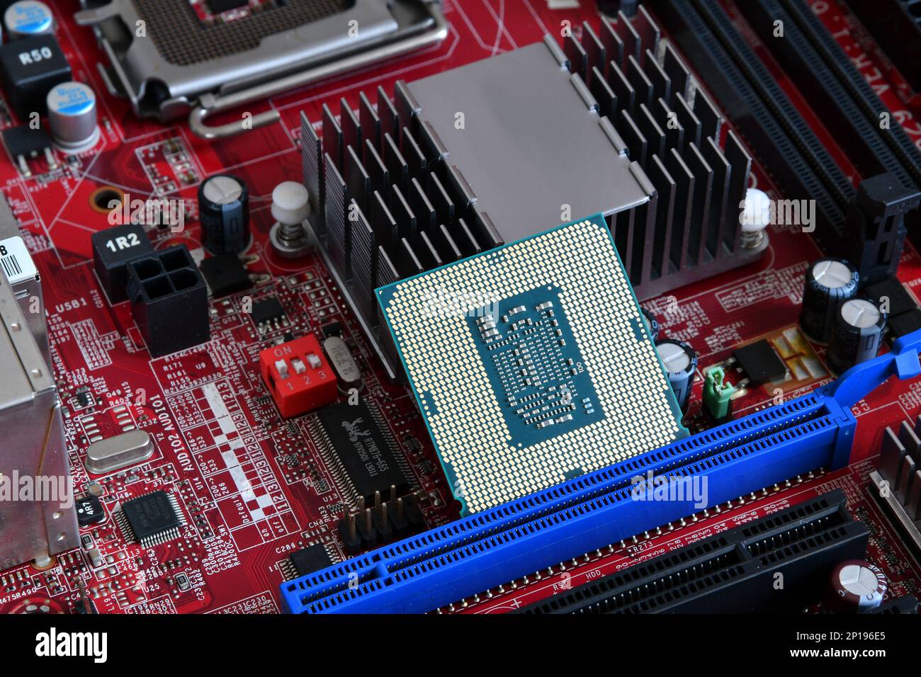 CPU socket and processor on the motherboard. Before installation processor. Motherboard digital ...