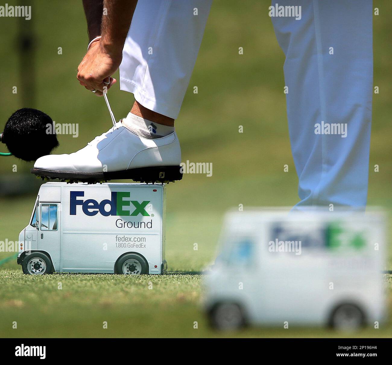 Camilo Villegas uses the little FedEx truck to tie his shoes on the 8th ...