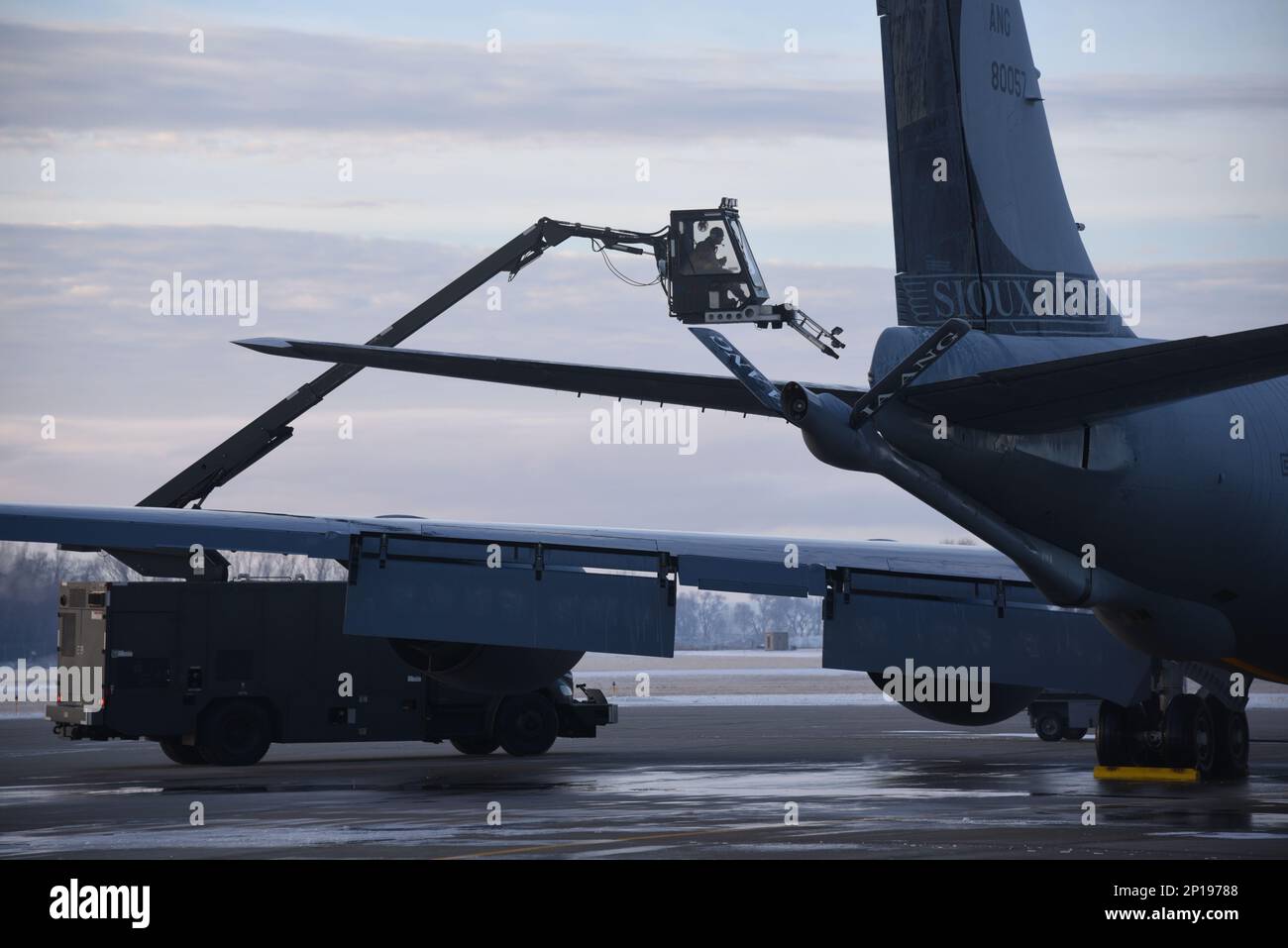 A crew chief from the Iowa Air National Guard uses “hot air blast” to ...