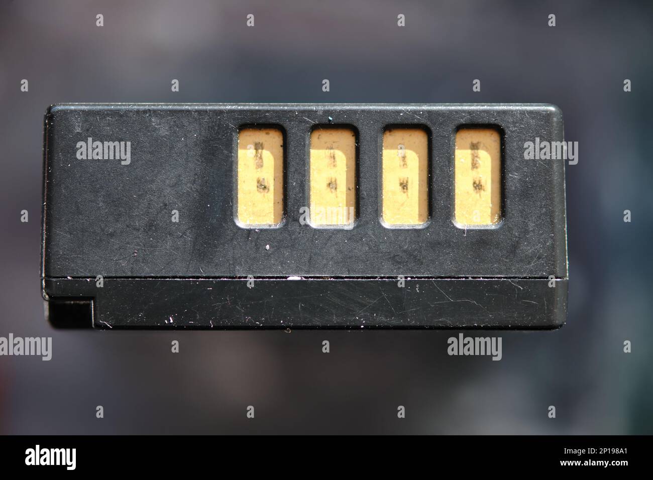 Close-up on used digital camera Li-ion battery with contacts. Isolated ...
