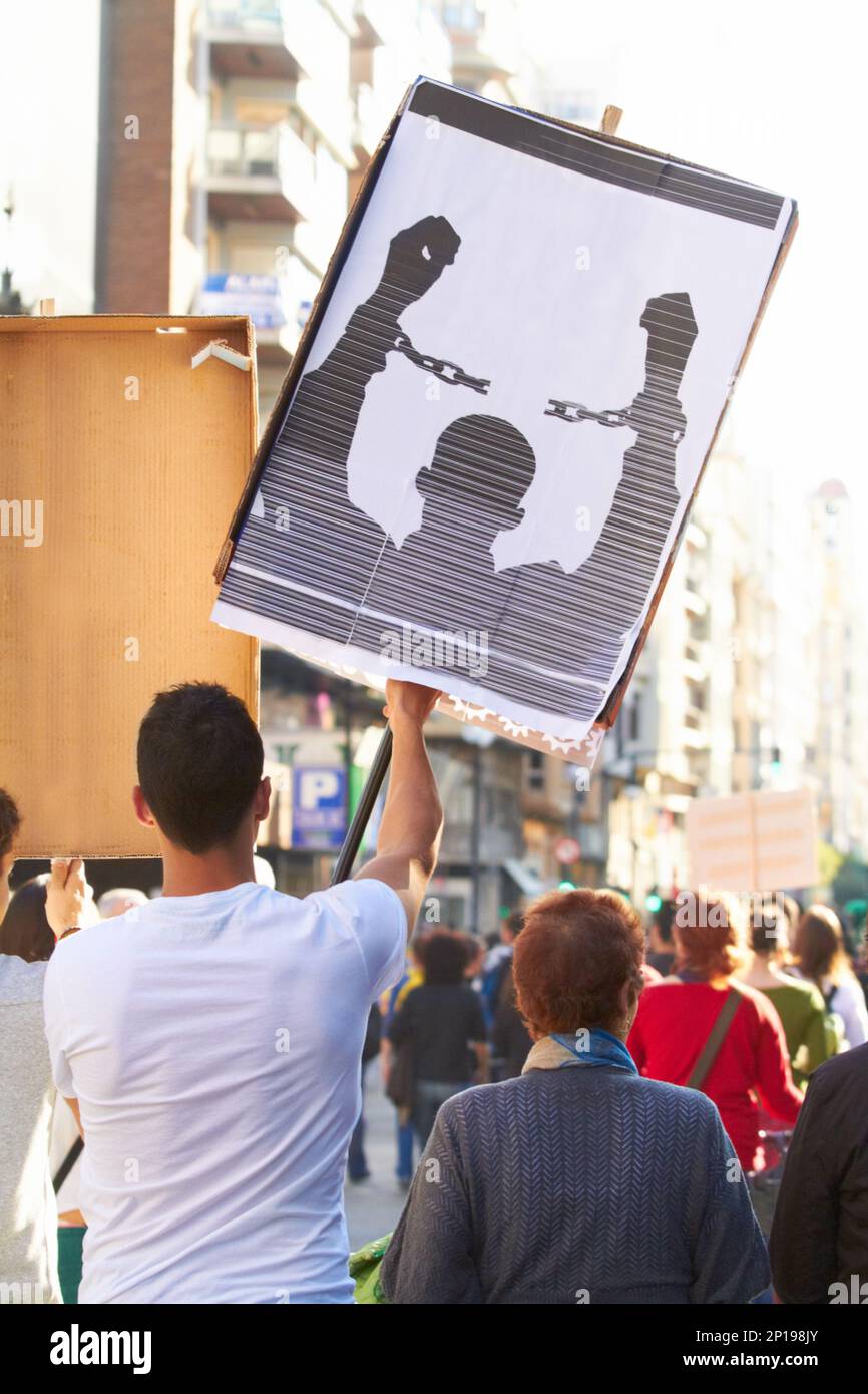 We want freedom. Rearview shot of a group of protestors with placard ...