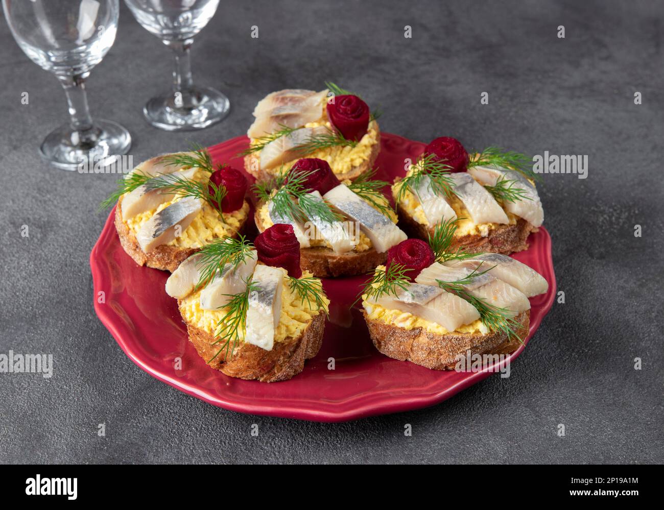 Homemade sandwiches with salted herring, cheese and egg, decorated with ...