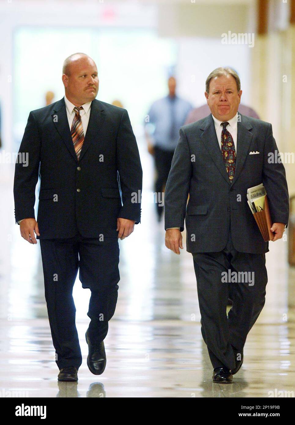 Jimmy Fennell Jr, left, walks down the hallway with his lawyer Bob ...