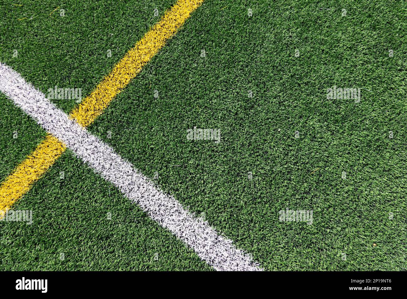 Green artificial grass turf soccer football field background with white ...