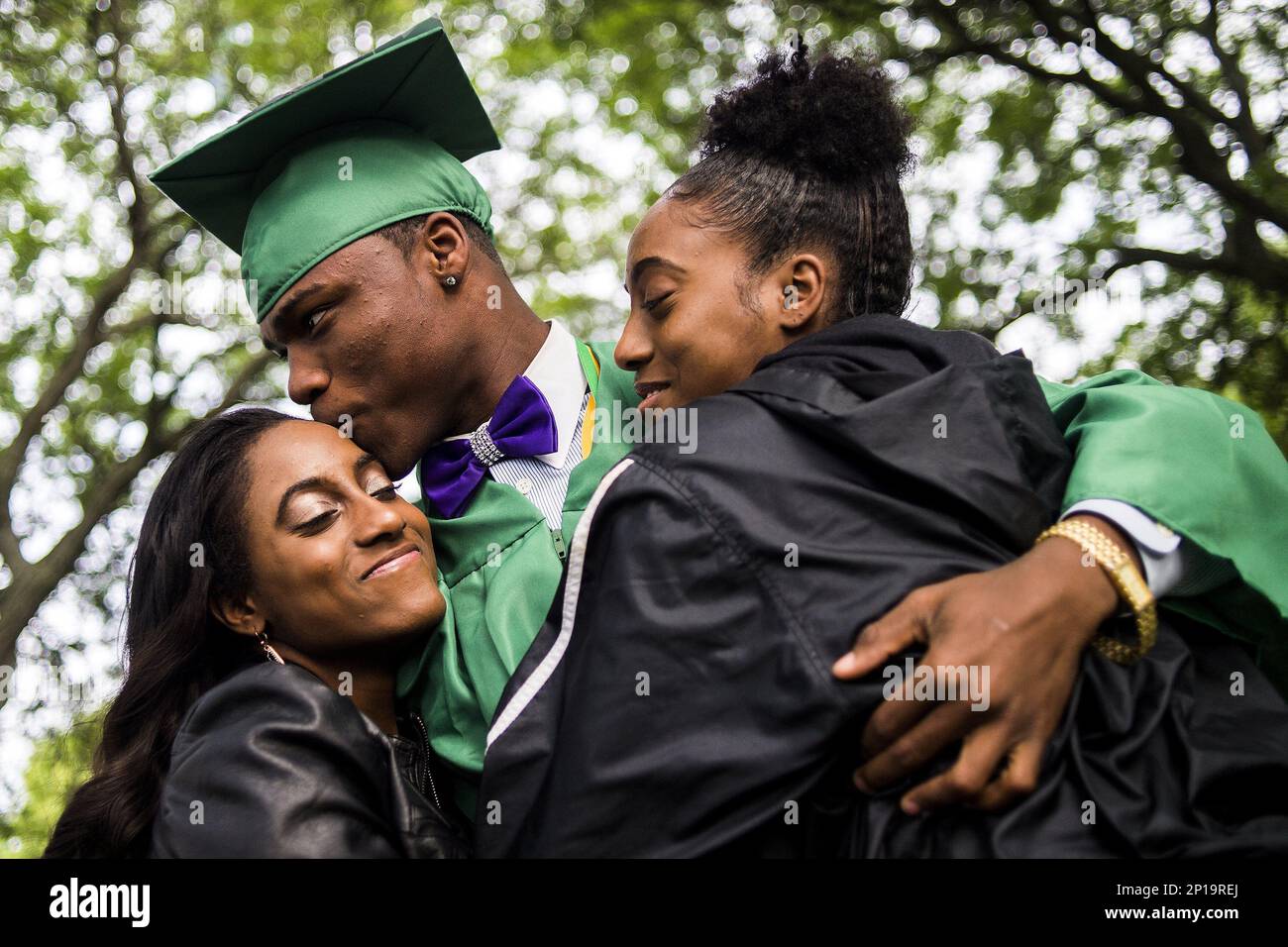 Flint Northwestern graduate Antwoin Nelson, 18, embraces both of his ...