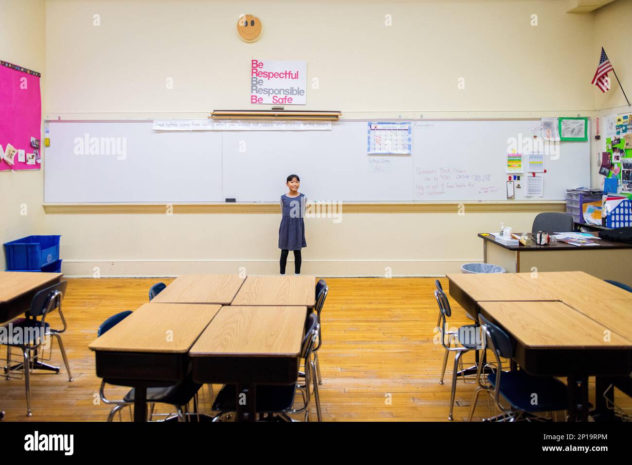 Young asian girl standing in elementary school classroom Stock Photo ...