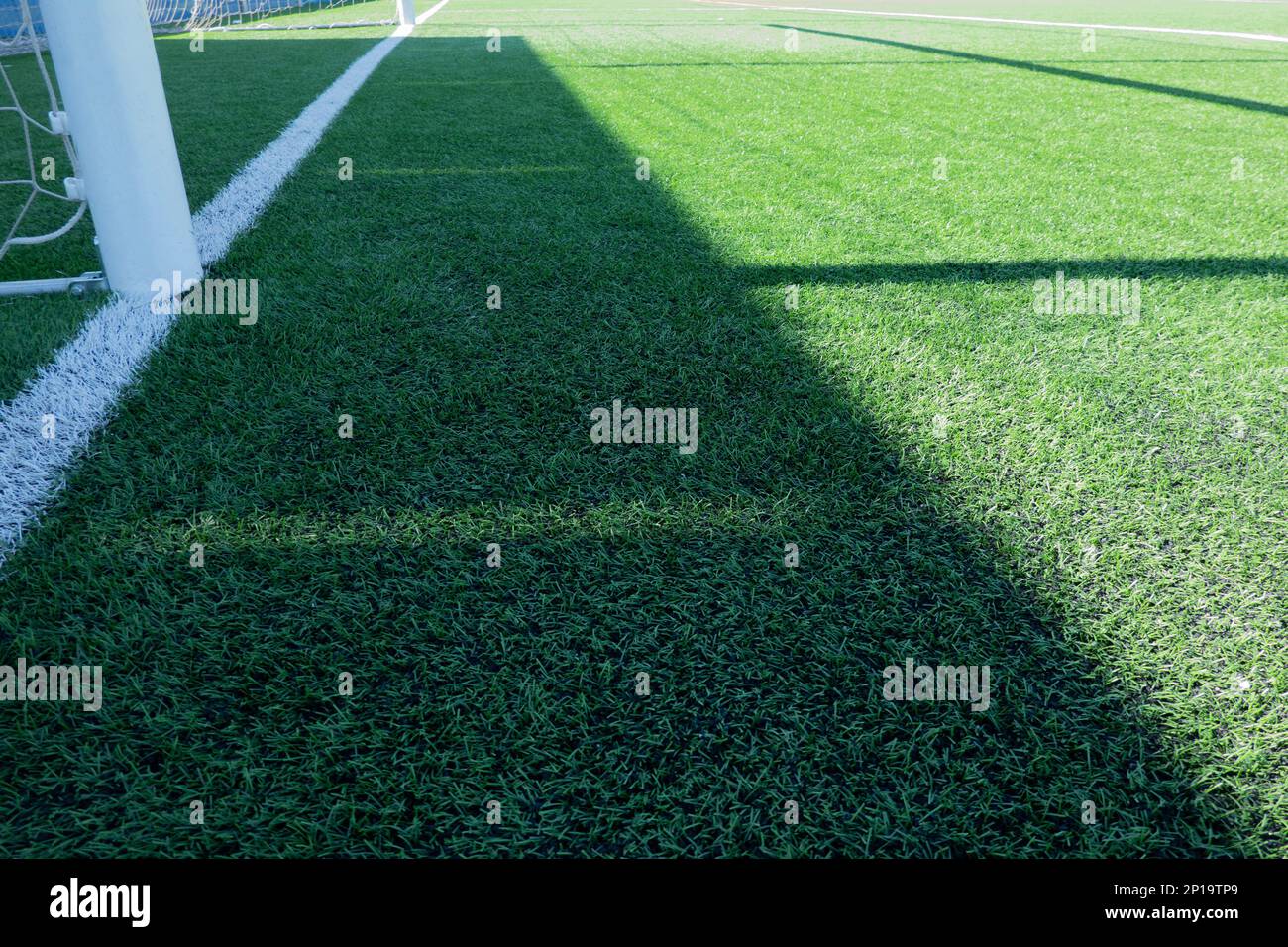 Artificial turf on football soccer field. Part of soccer goal and green ...