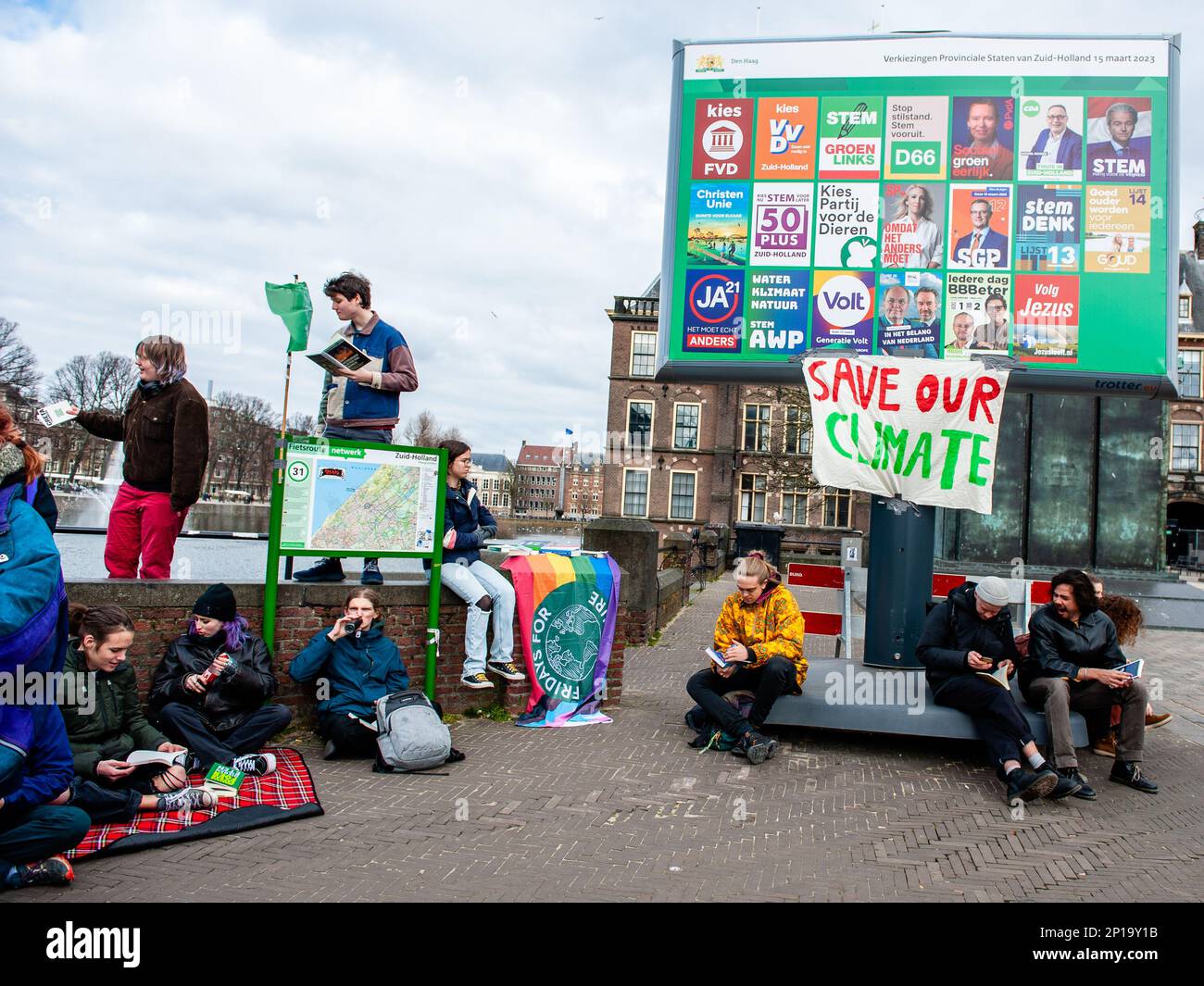 A billboard with political parties on it is seen decorated with a ...