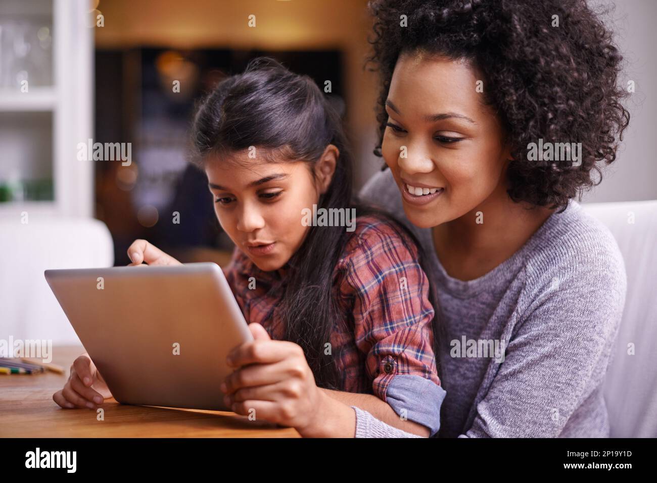 Everyday you learn something new. Shot of a mother and daughter using a ...