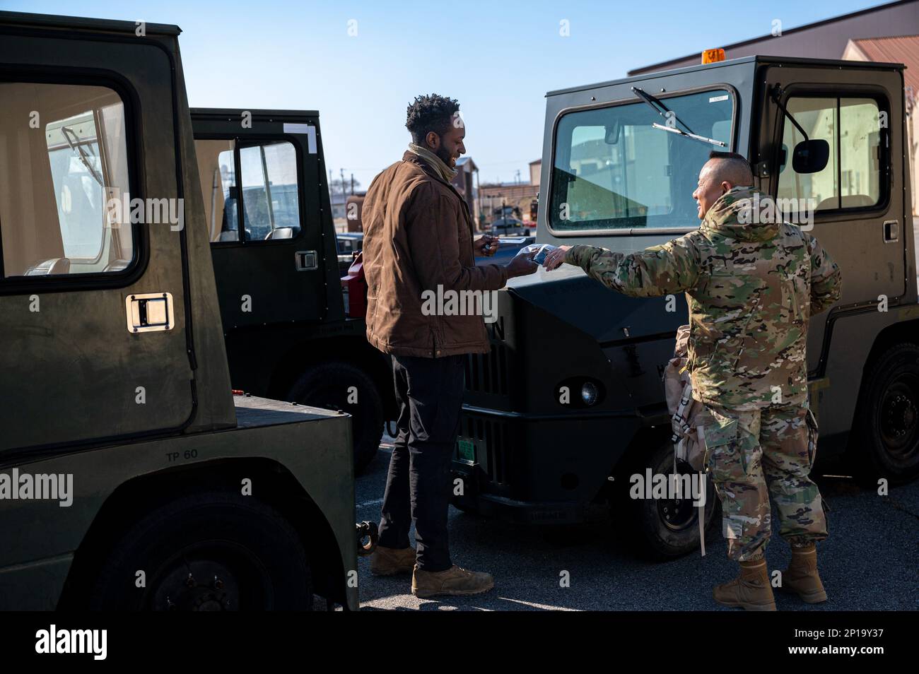 U.S. Air Force Capt. Alex Lu, 51st Fighter Wing chaplain, gifts a cold ...