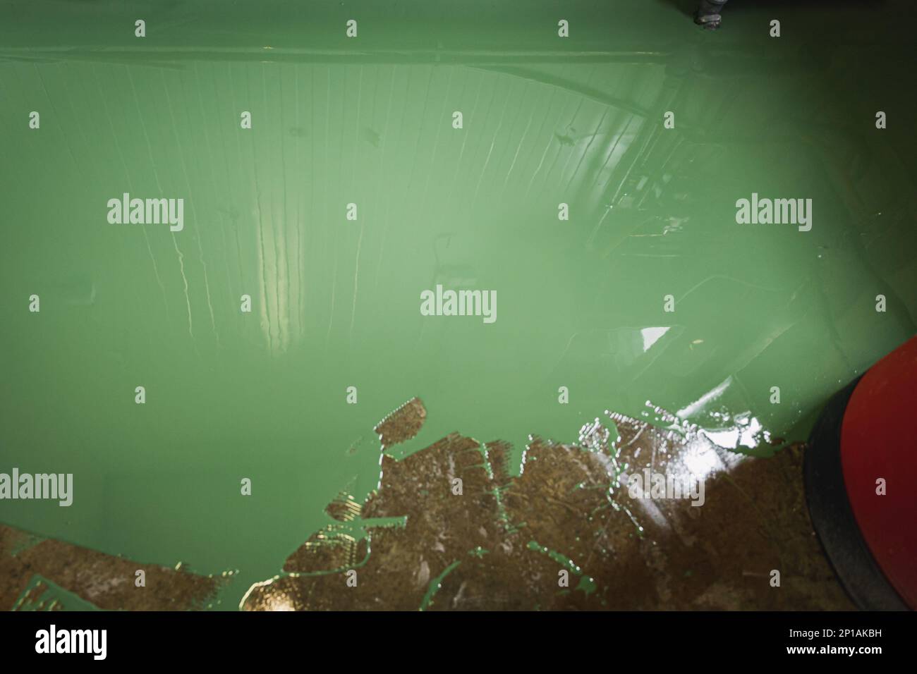 Floor under renovation with green epoxy resin.Applied over polished and ...