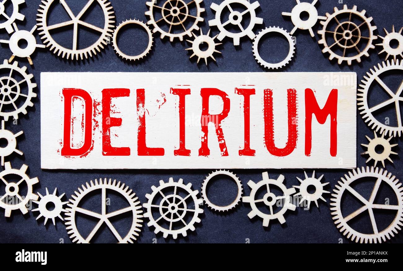 word delirium made of wooden letters on a gray table on a green ...