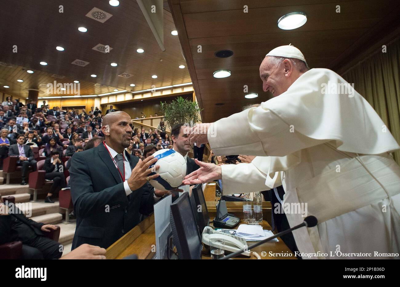 Pope Francis receives a soccer ball at a meeting with the Scholas ...