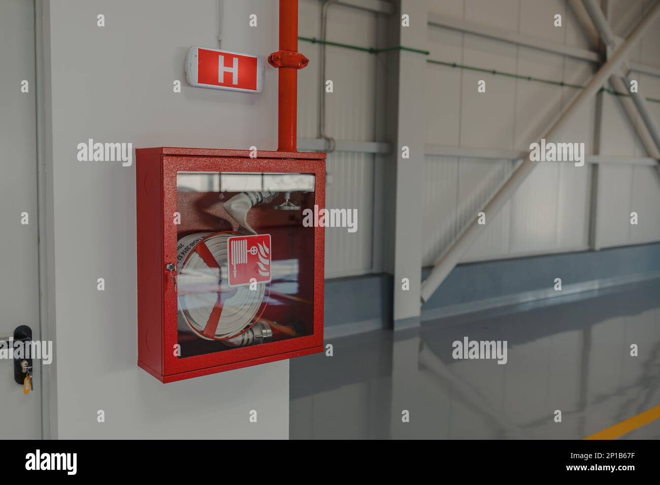 Fire Hose cabinet in the building and light signal Stock Photo - Alamy